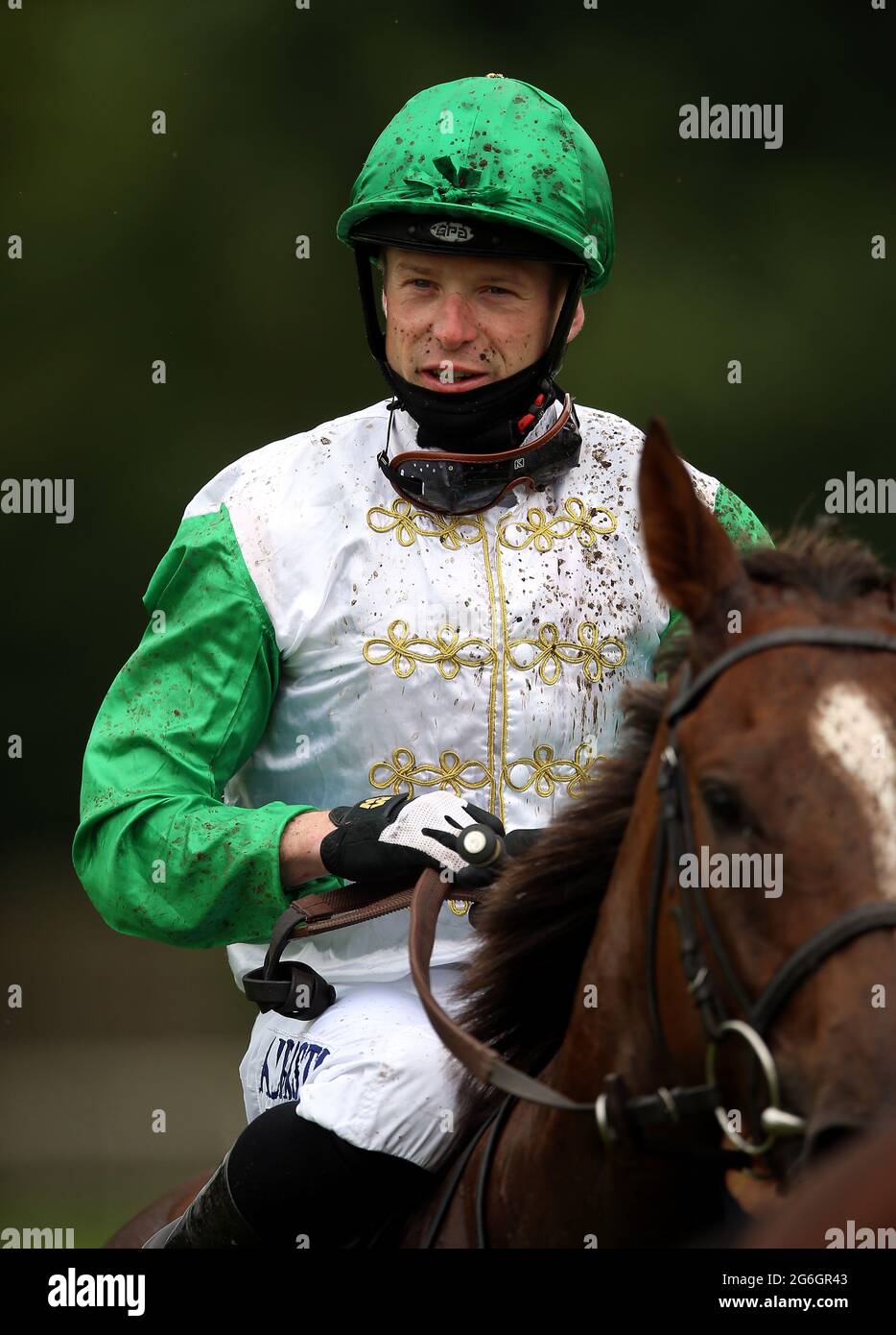 Jockey Jack Mitchell covered in mud after the Dianne Nursery Handicap ...