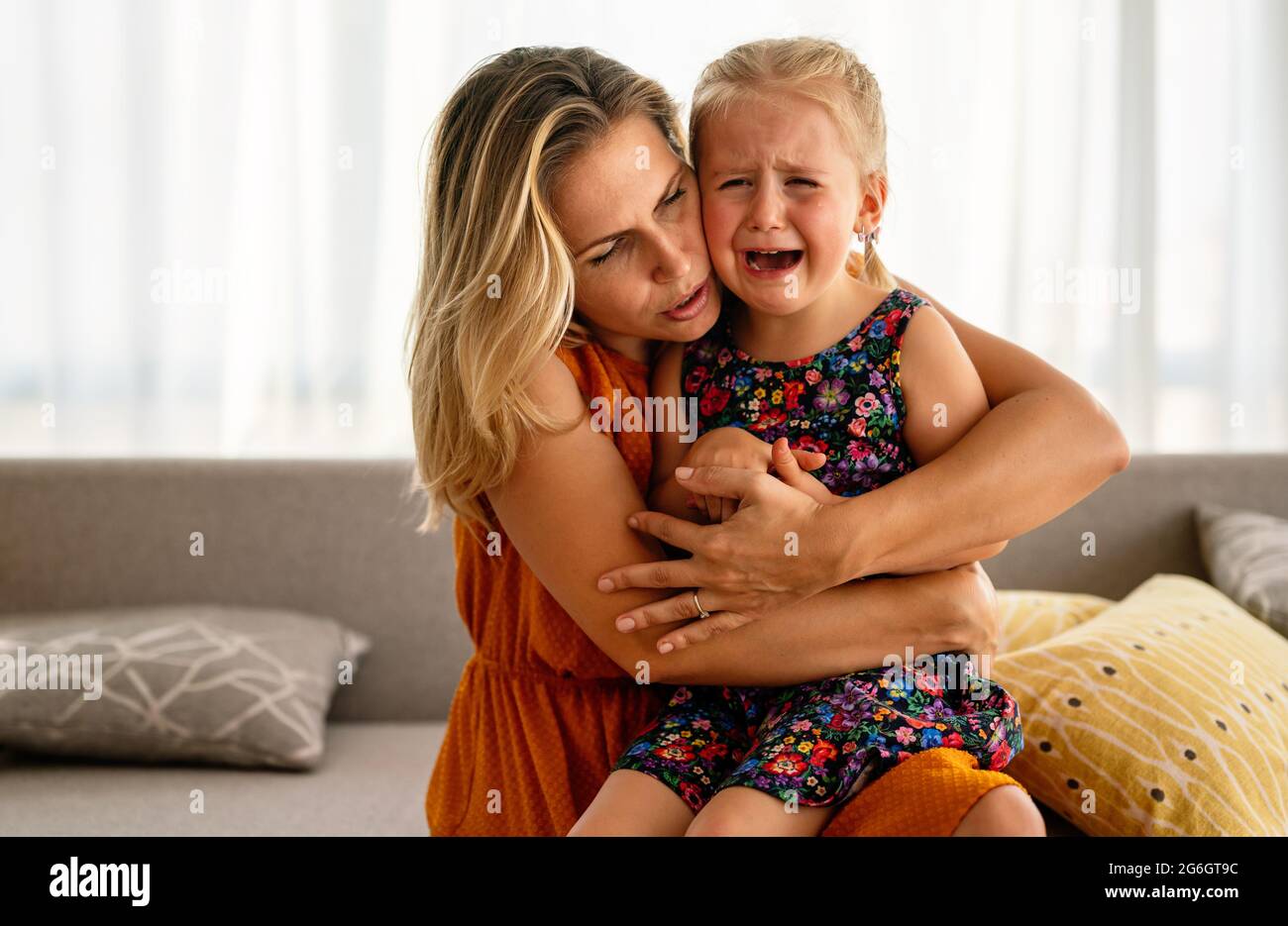Mother comforting her crying little girl. Parenthood, family support ...