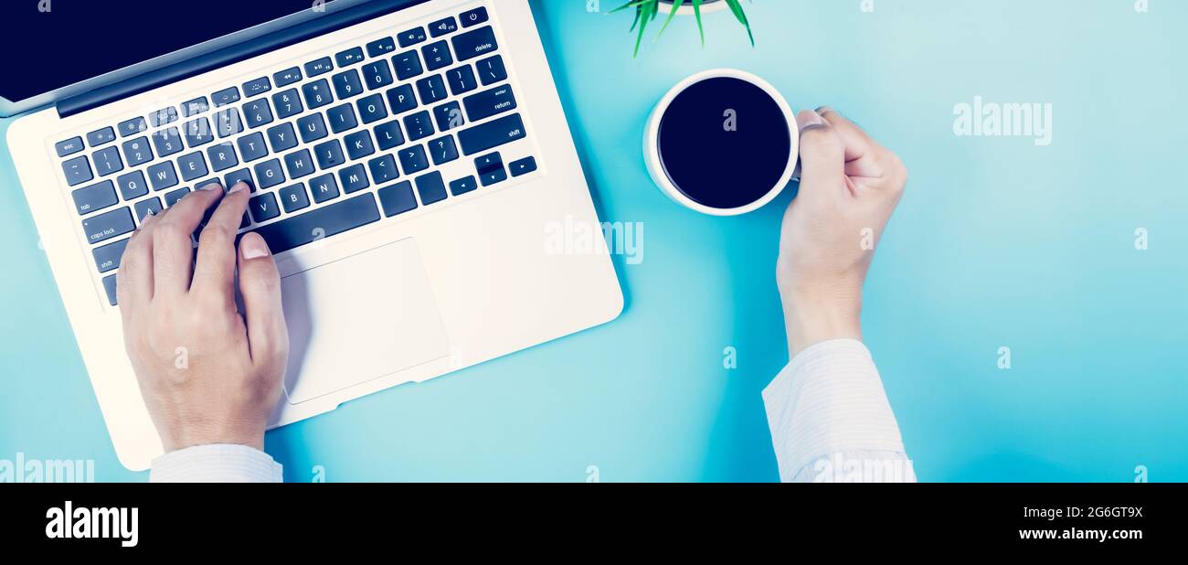 Flat lay, hand of businessman working on Laptop computer with plant and ...