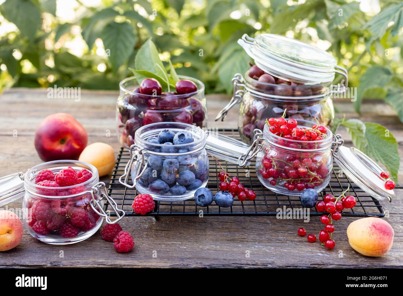 set of various fresh seasonal berries on garden table Stock Photo - Alamy