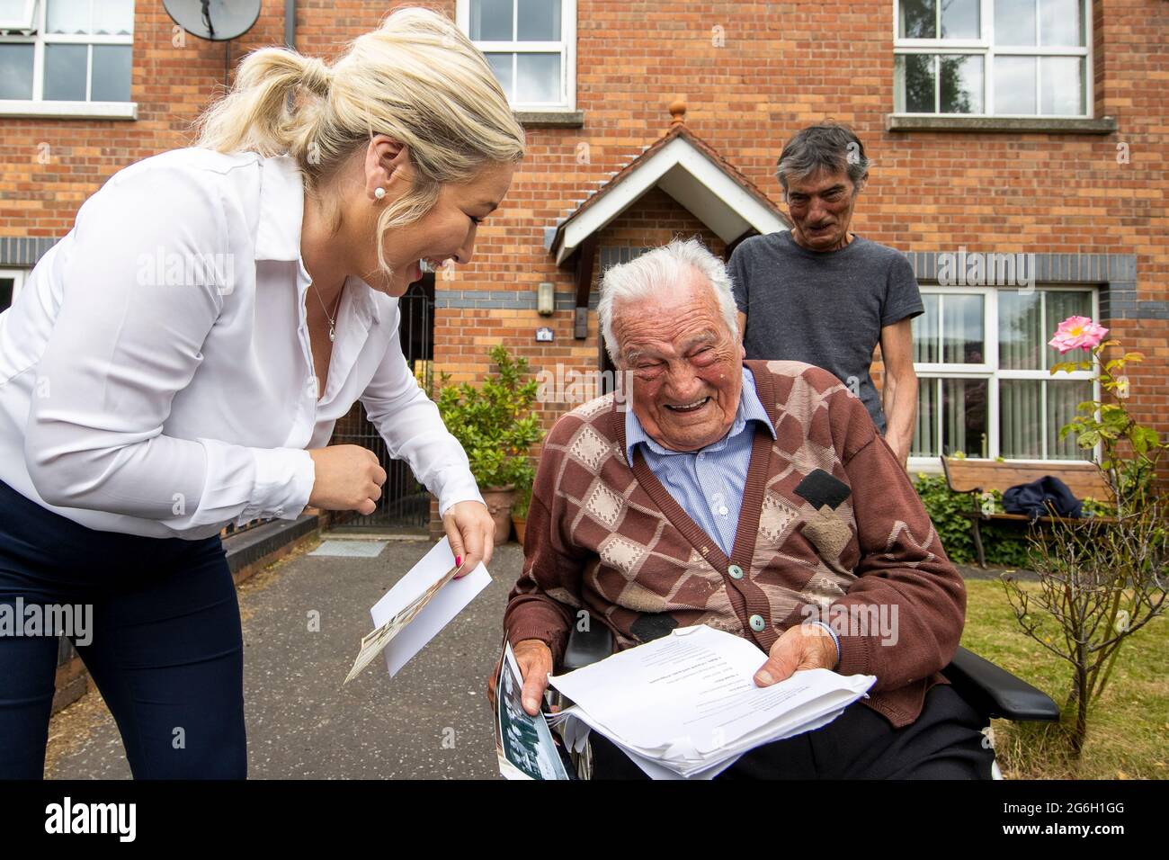 Deputy First Minister Michelle O'Neill alongside local resident Terence ...