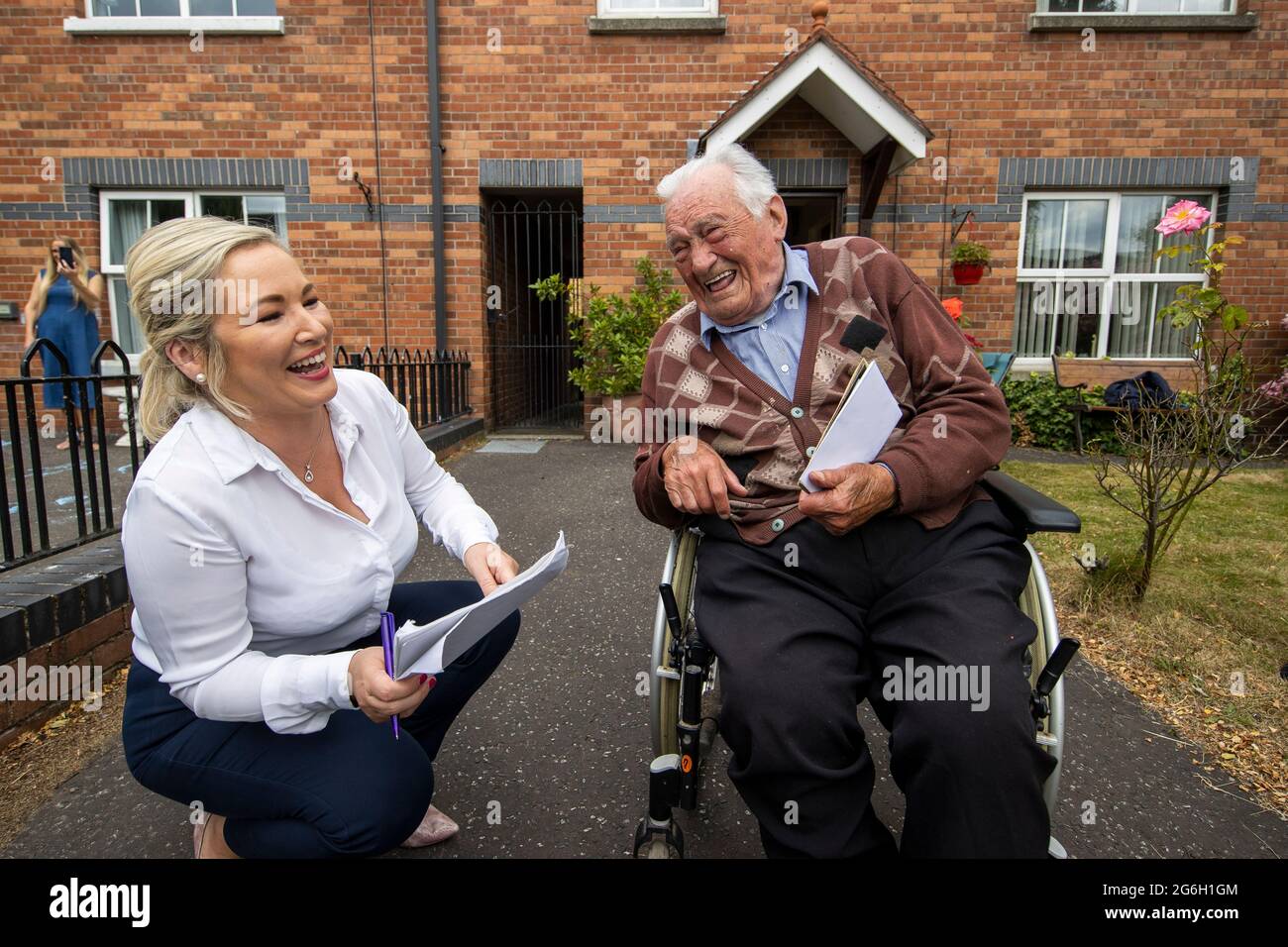 Deputy First Minister Michelle O'Neill alongside local resident Terence ...