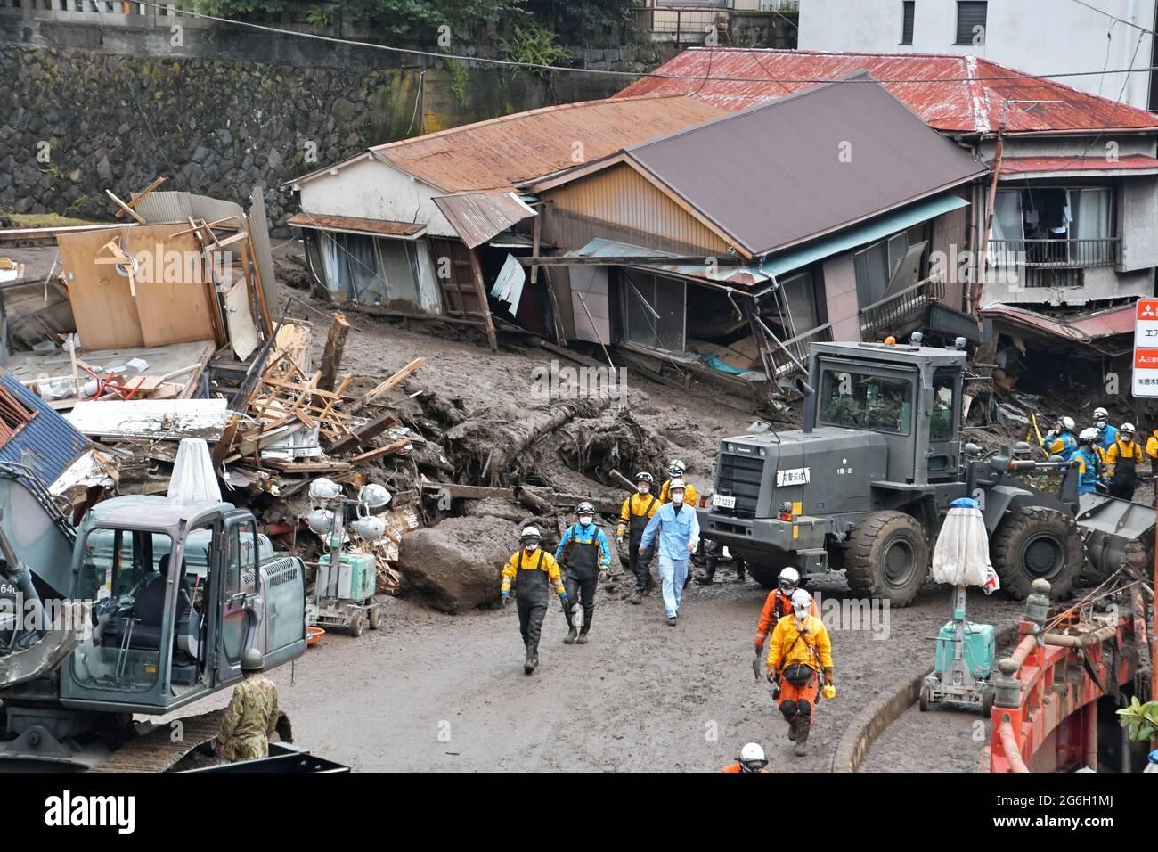 Atami, Japan. 06th July, 2021. Rescue workers search through the debris ...