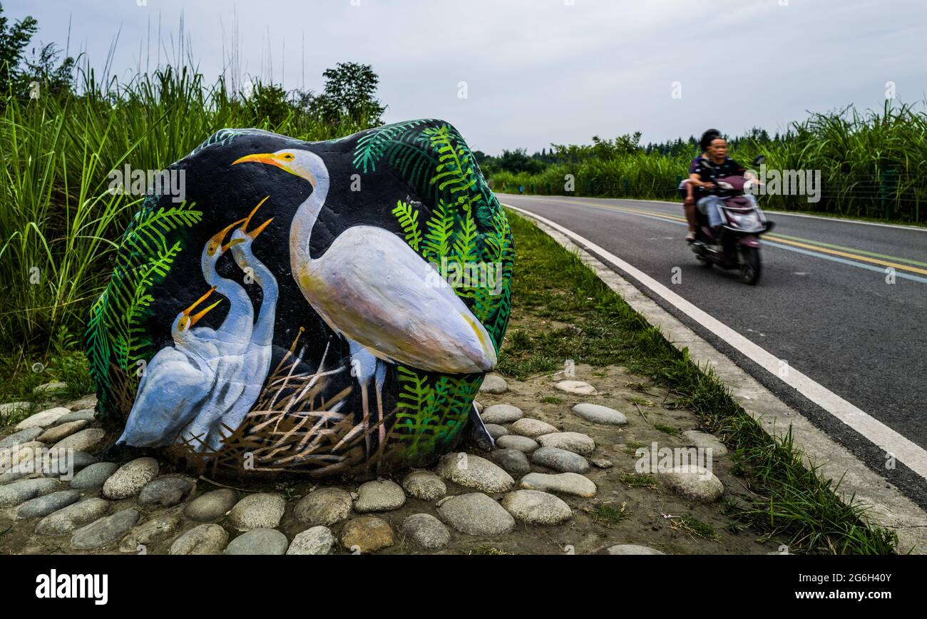 Vivid stone painting at Jinma River stone art corridor attracts ...