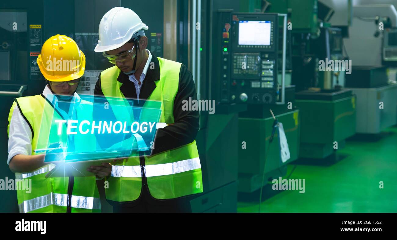 Asian engineers male female in Industrial wear hard hats in Industry ...