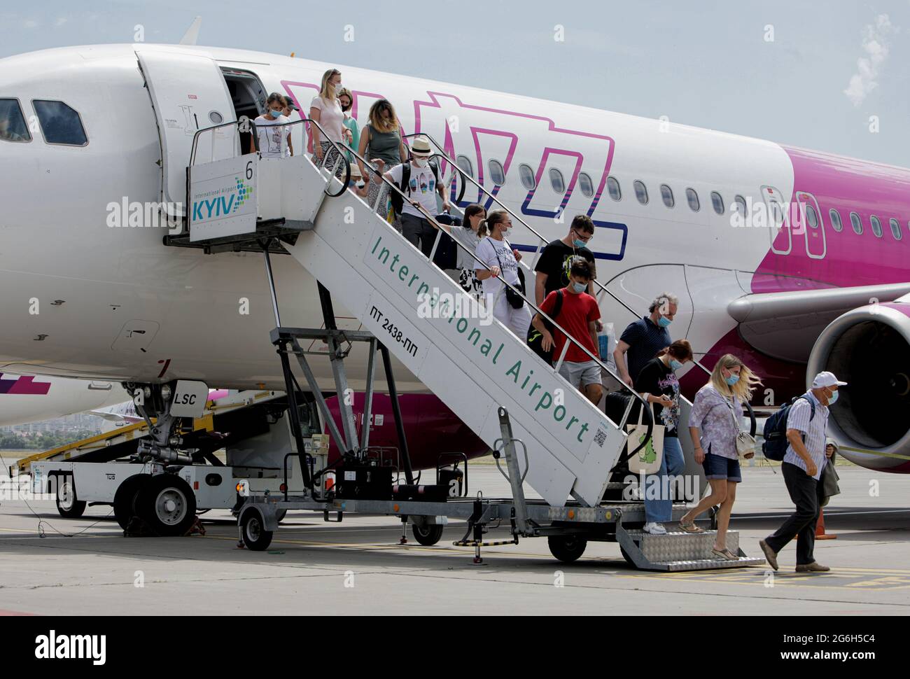KYIV, UKRAINE - JUNE 24, 2021 - Passengers alight from a plane at the ...