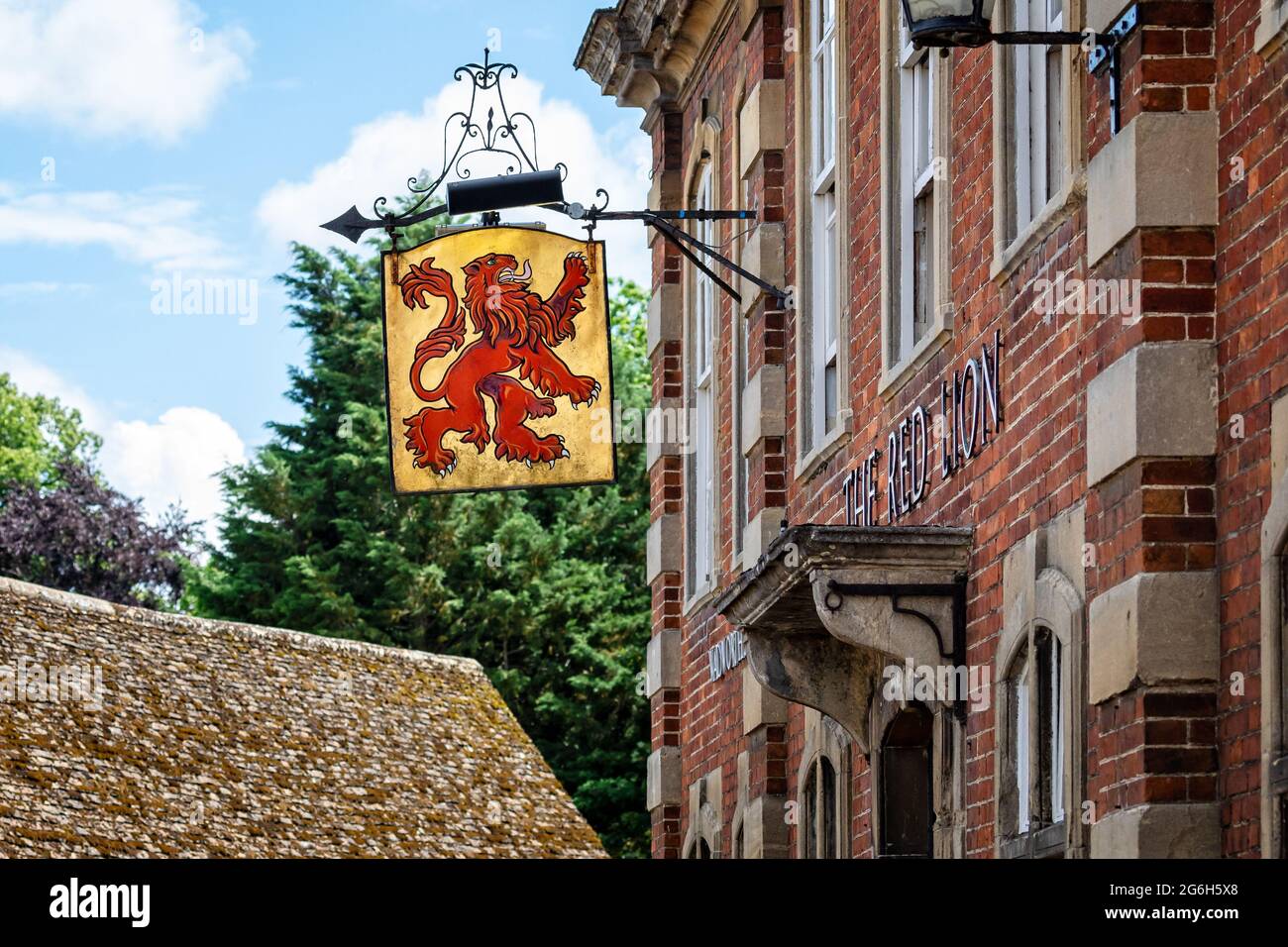 The Red Lion pub sign hanging outside The Red Lion in Lacock, Wilthsire ...