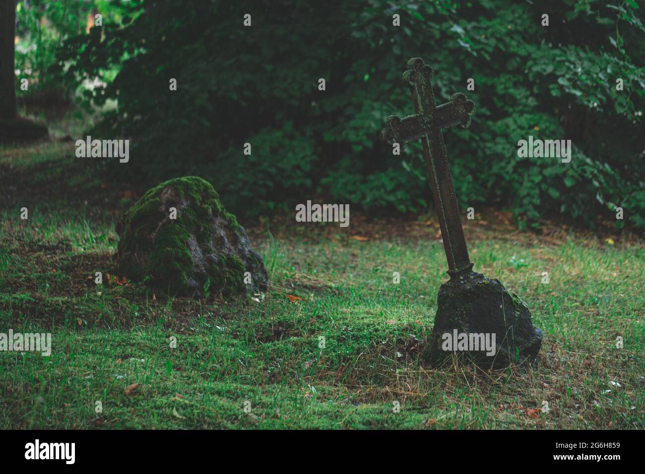Old Cemetery Cross. An old moss covered cross marks a grave. Green ...
