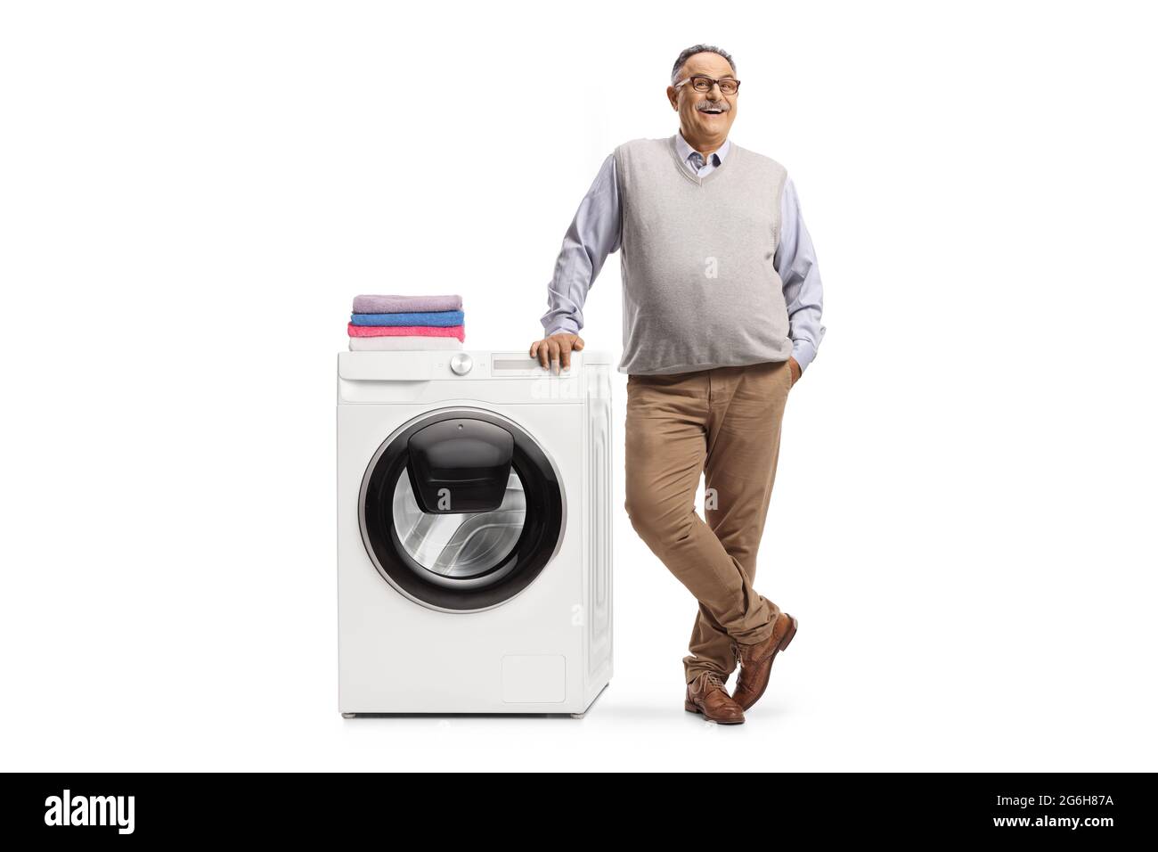 Smiling mature man leaning on a washing machine isolated on white ...