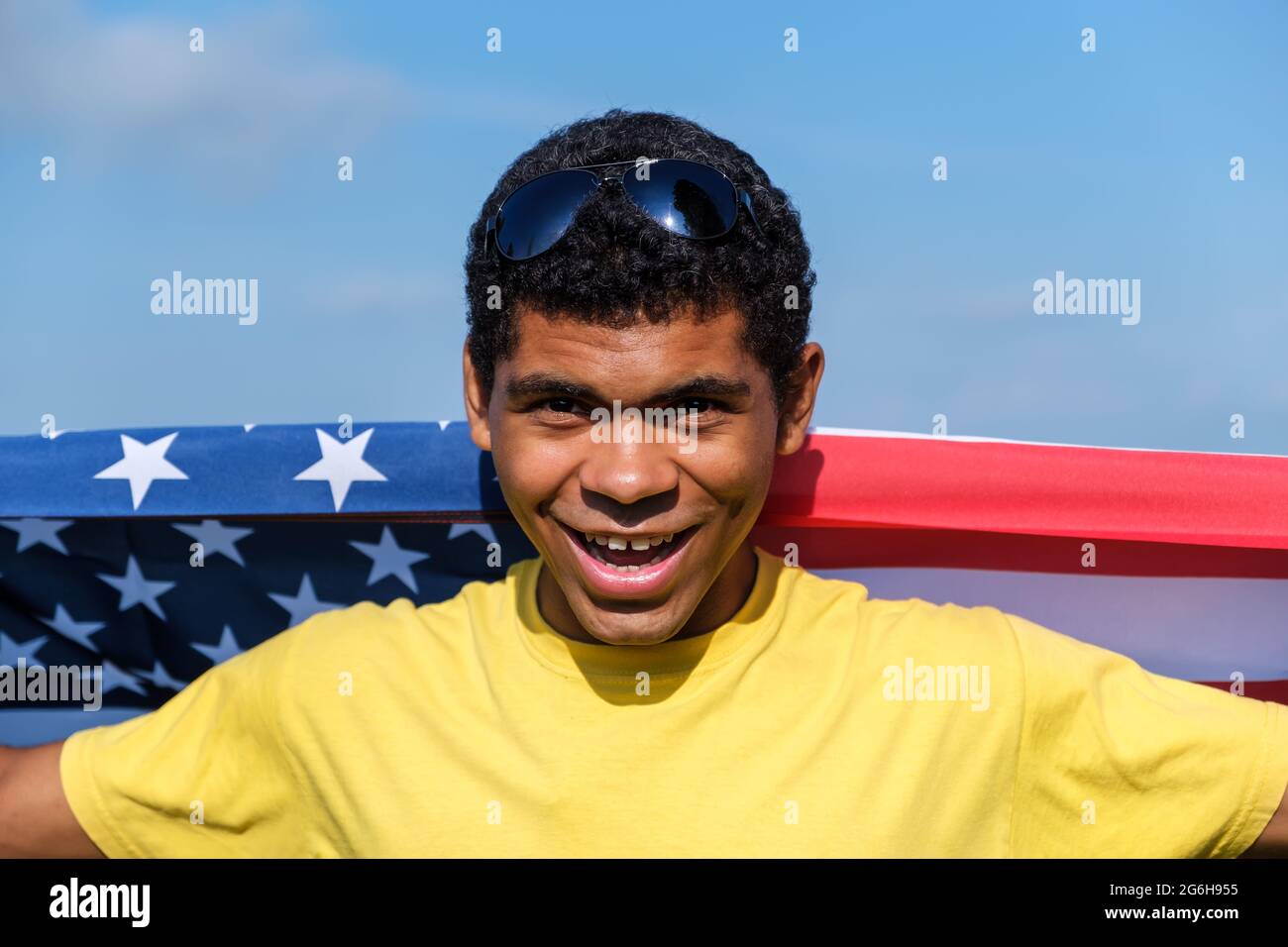 Man looking at camera and proudly holding American flag on his ...