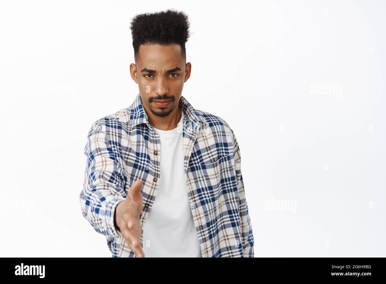 Serious and confident young african american man stretch out hand for ...