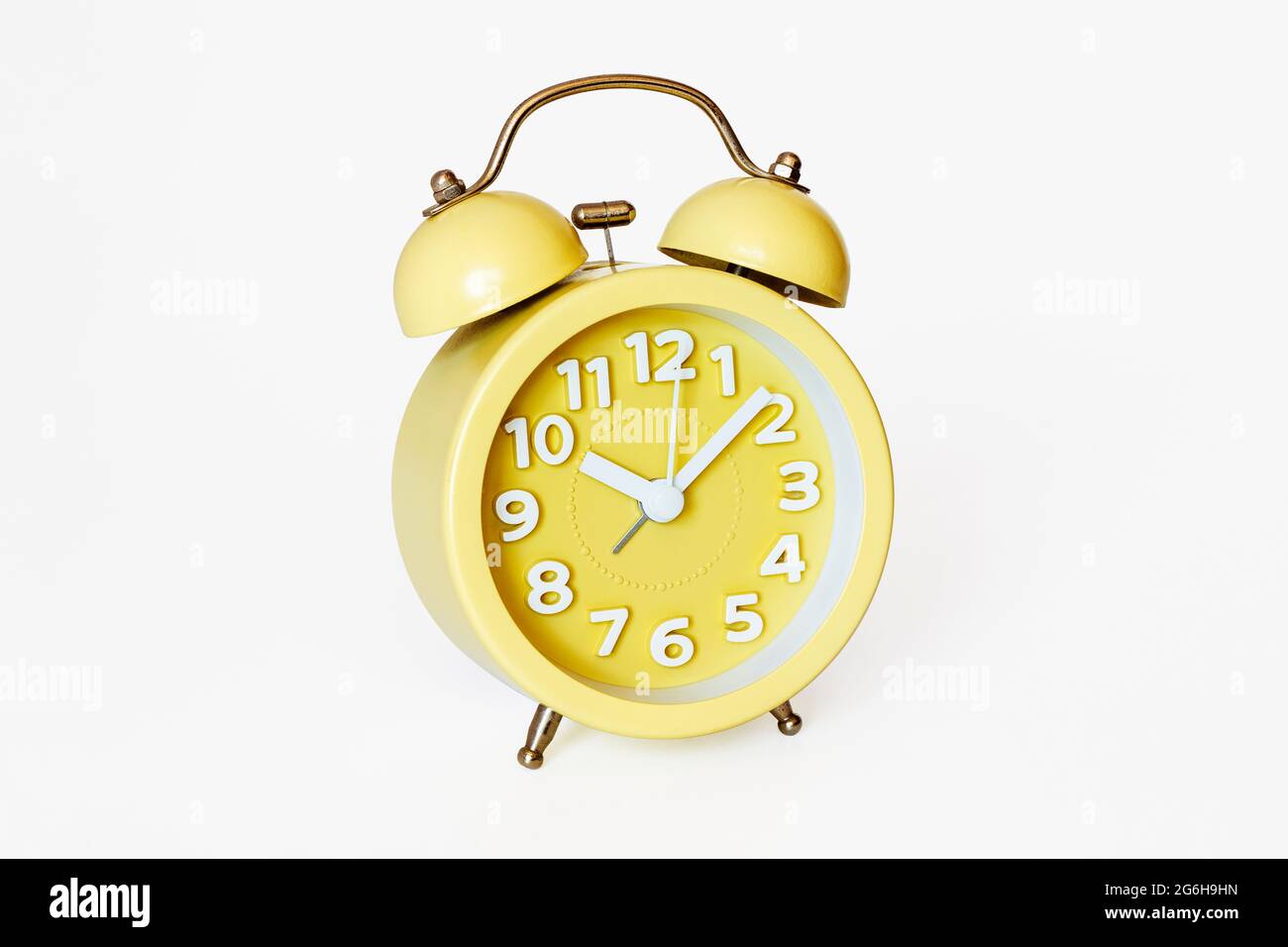 A traditional-style alarm clock with two bells isolated on a white ...