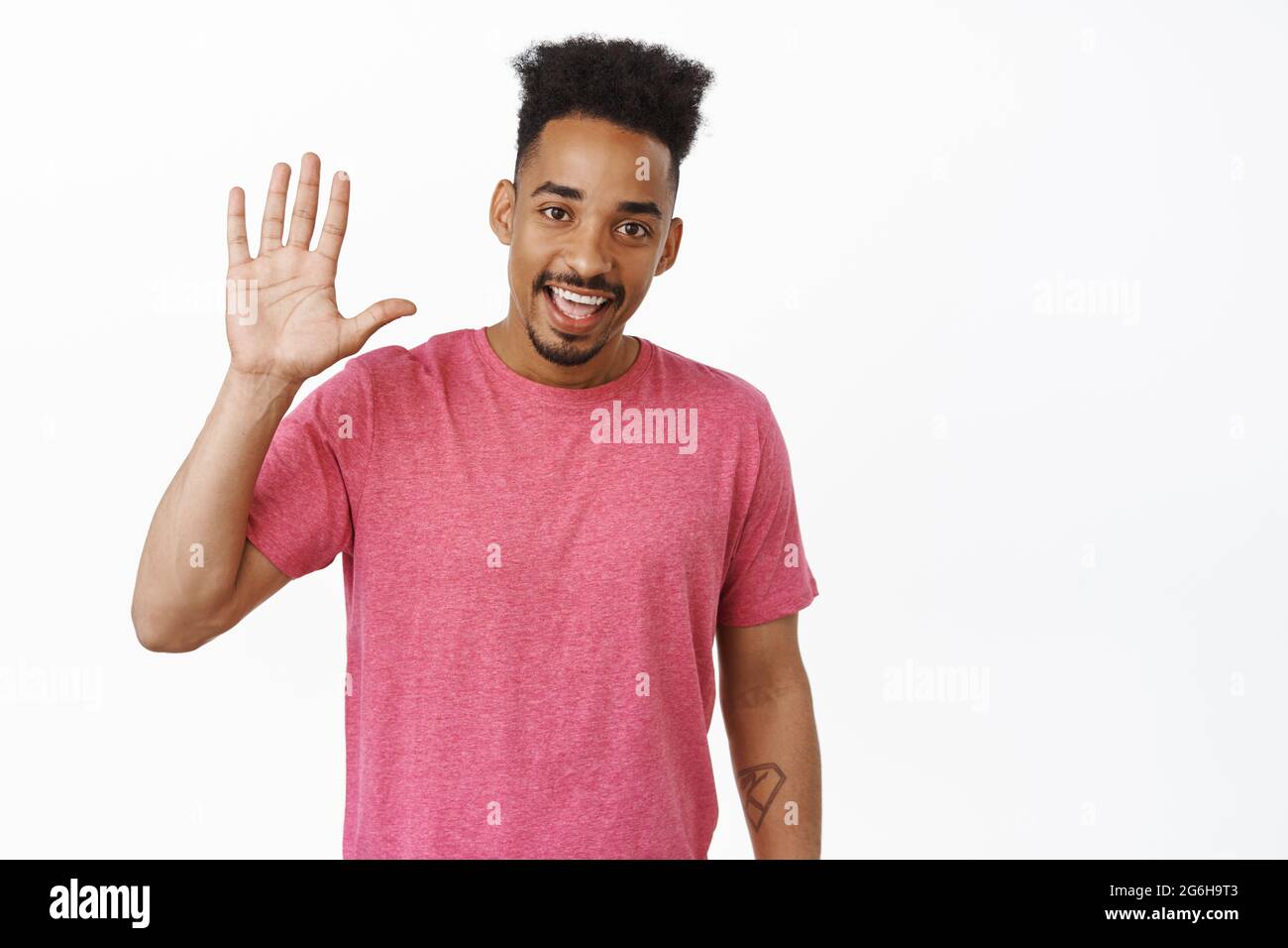 High five. Smiling african american guy raising hand up, waving hello ... High five. Smiling african american guy raising hand up, waving hello ...