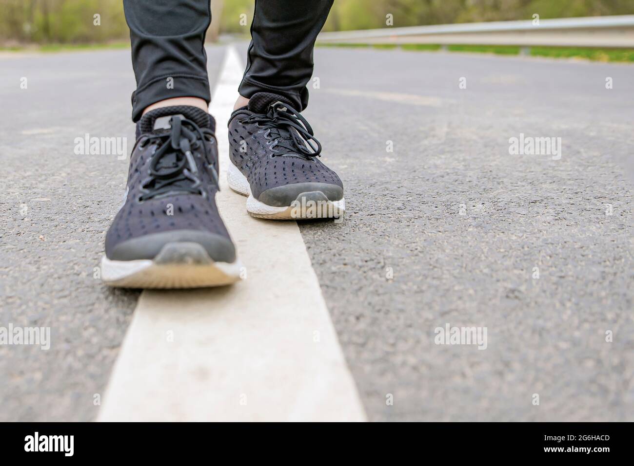 Morning run. Running feet while running, Runner in black sneakers runs ...