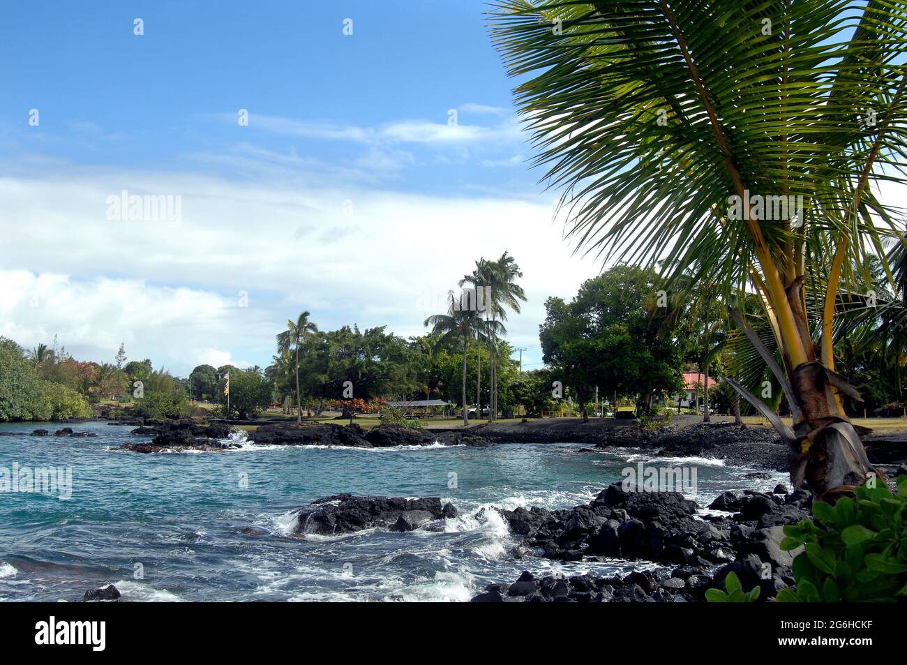 Bay view near Hilo, Hawaii. Small memorial park flies flag of Japan and ...