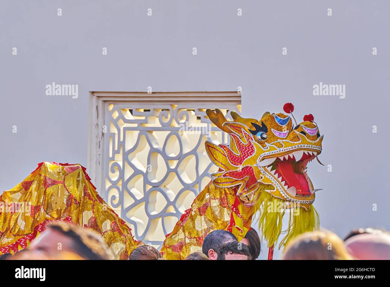 Giant traditional Chinese golden Dragon dancing around crowd in Chinese ...
