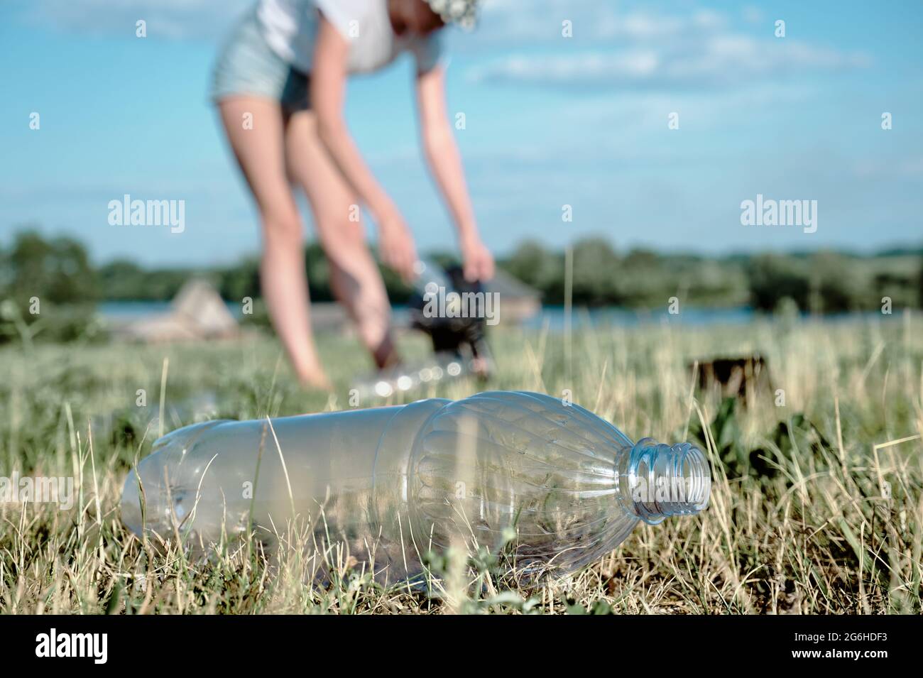 Collecting plastic garbage. The girl collects plastic bottles ...