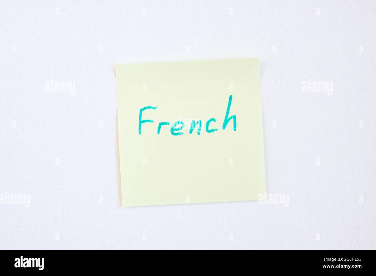 Top view flat lay of the reminder notepaper of yellow color with word ...