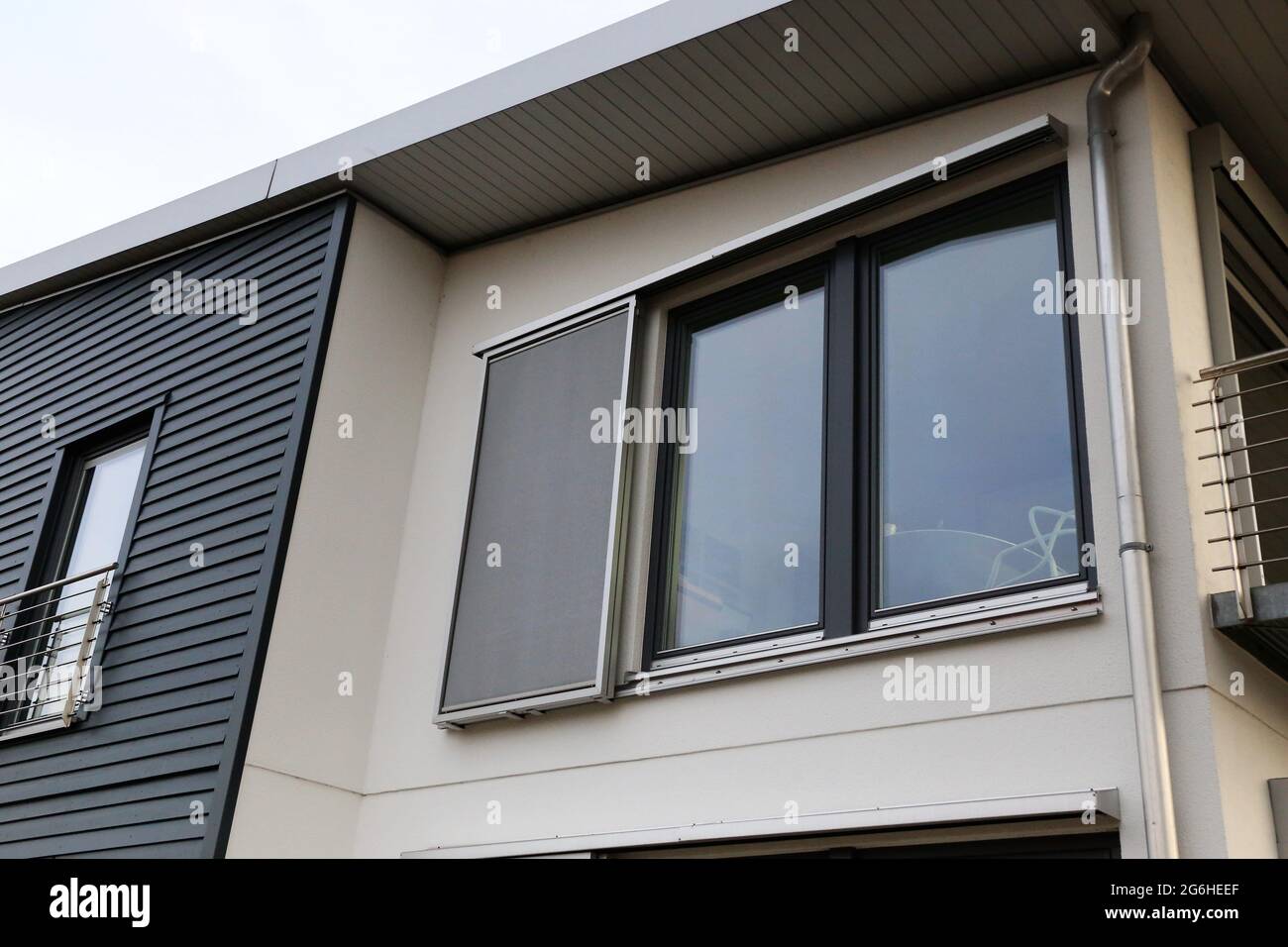 Windows with modern sliding shutters Stock Photo - Alamy