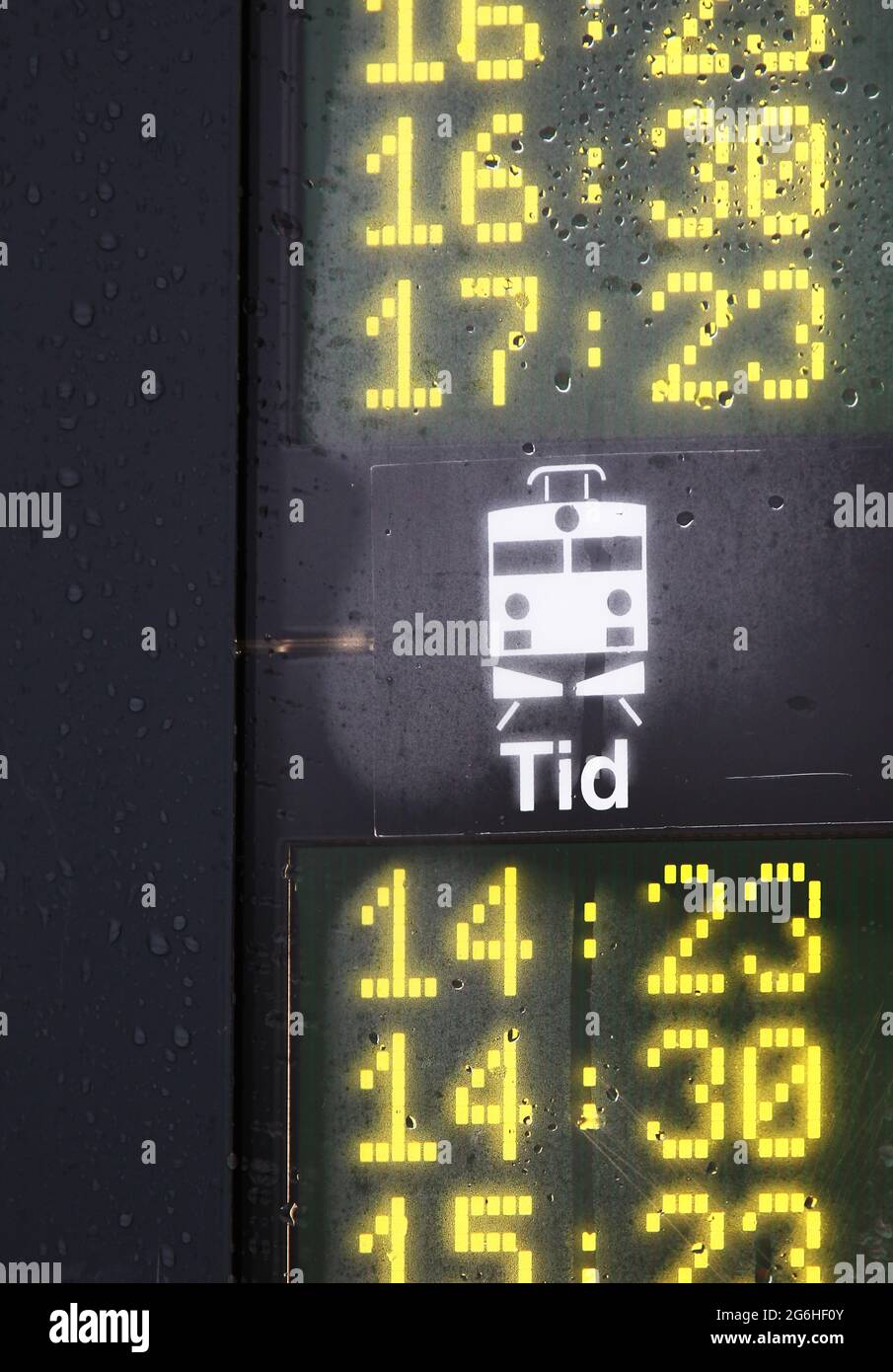 Information sign, showing a timetable for trains, at a central station ...
