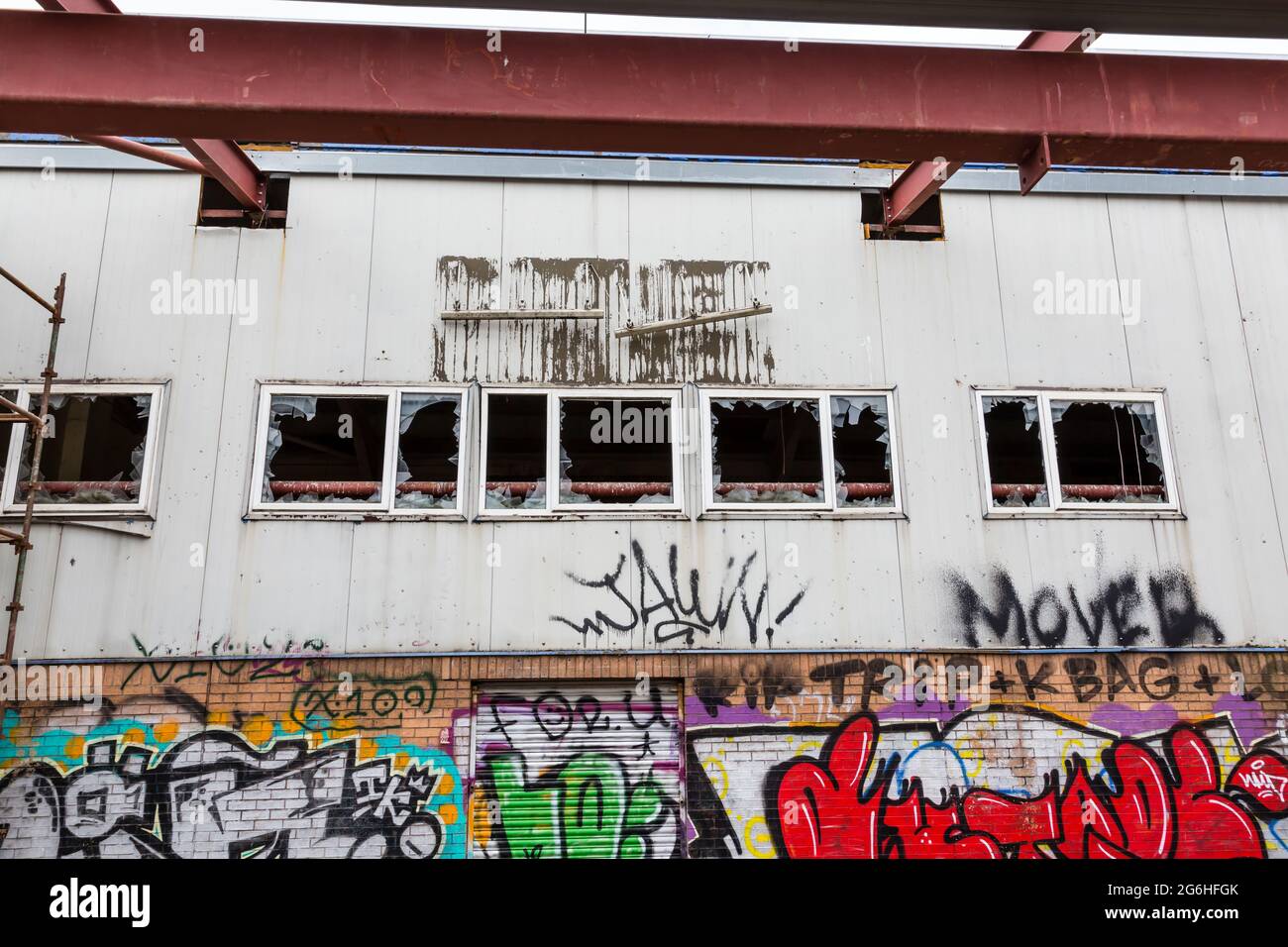 Exterior of an old industrial building with broken windows and graffiti ...