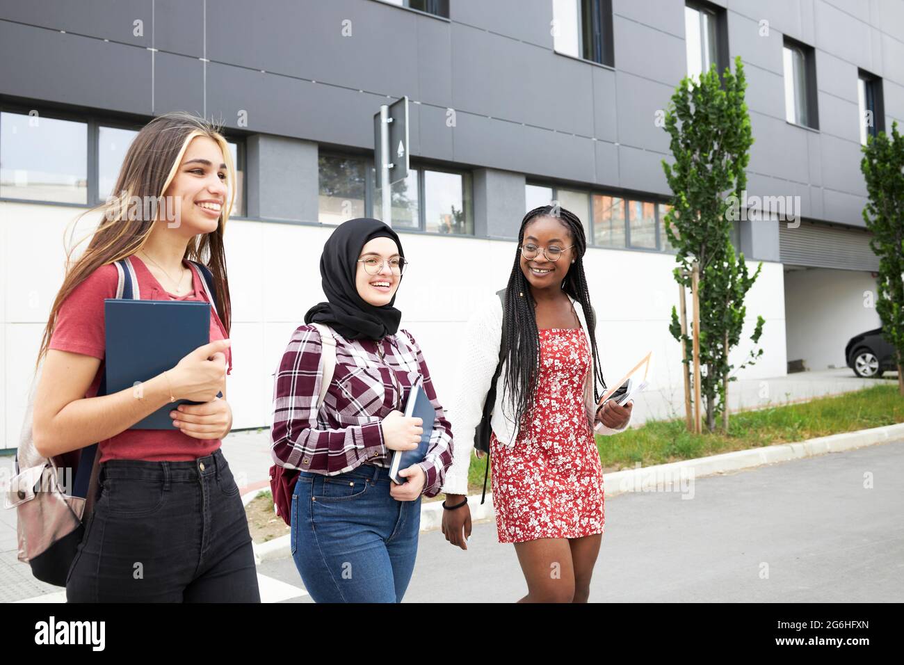 Teenage friends going to their class Stock Photo - Alamy
