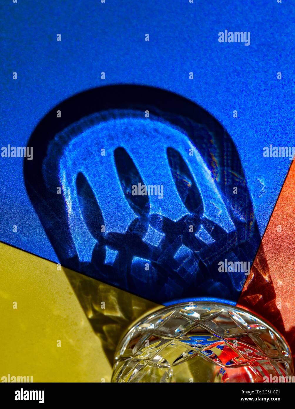 Still-life of crystal glass and prominent reflection pattern on ...