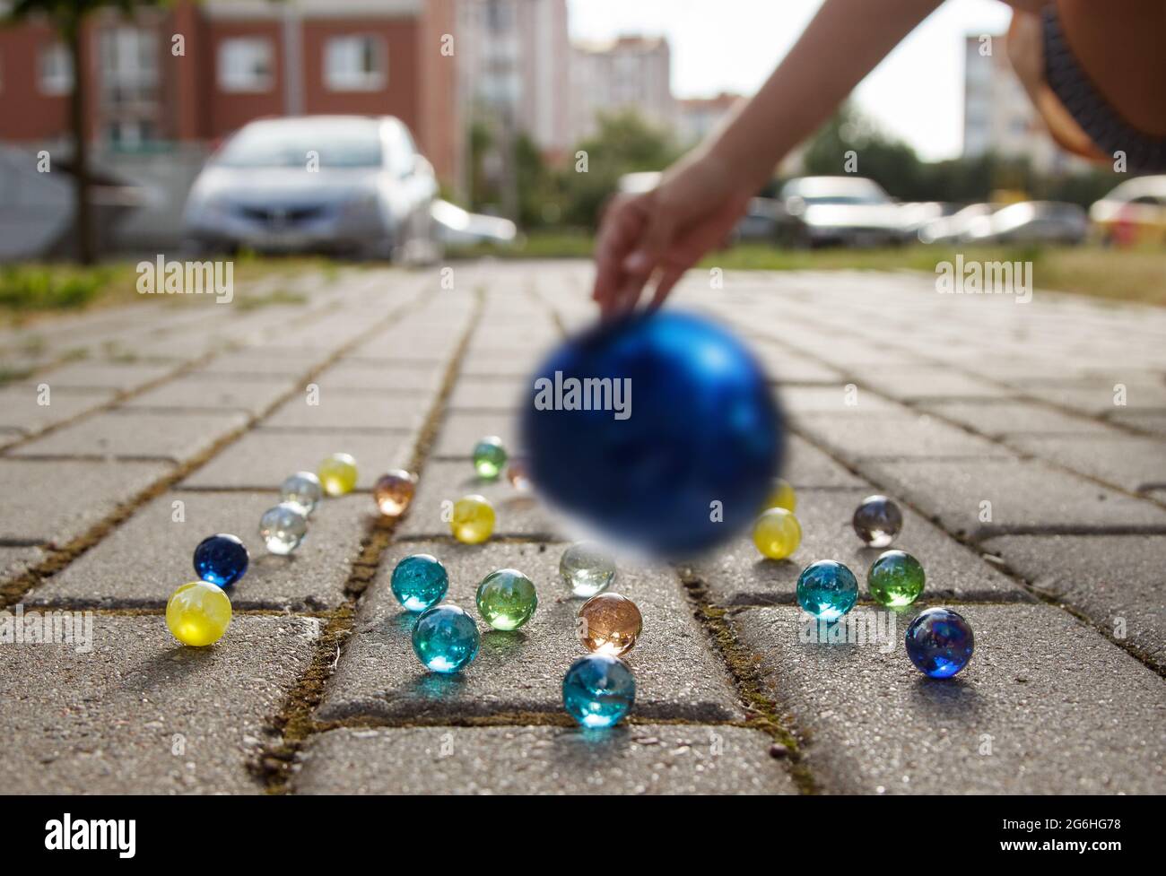 girl throws a glass ball on the sidewalk outdoor closeup Stock Photo ...