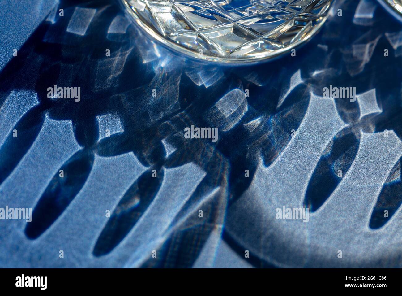 Still-life of crystal glass and prominent reflection pattern on ...