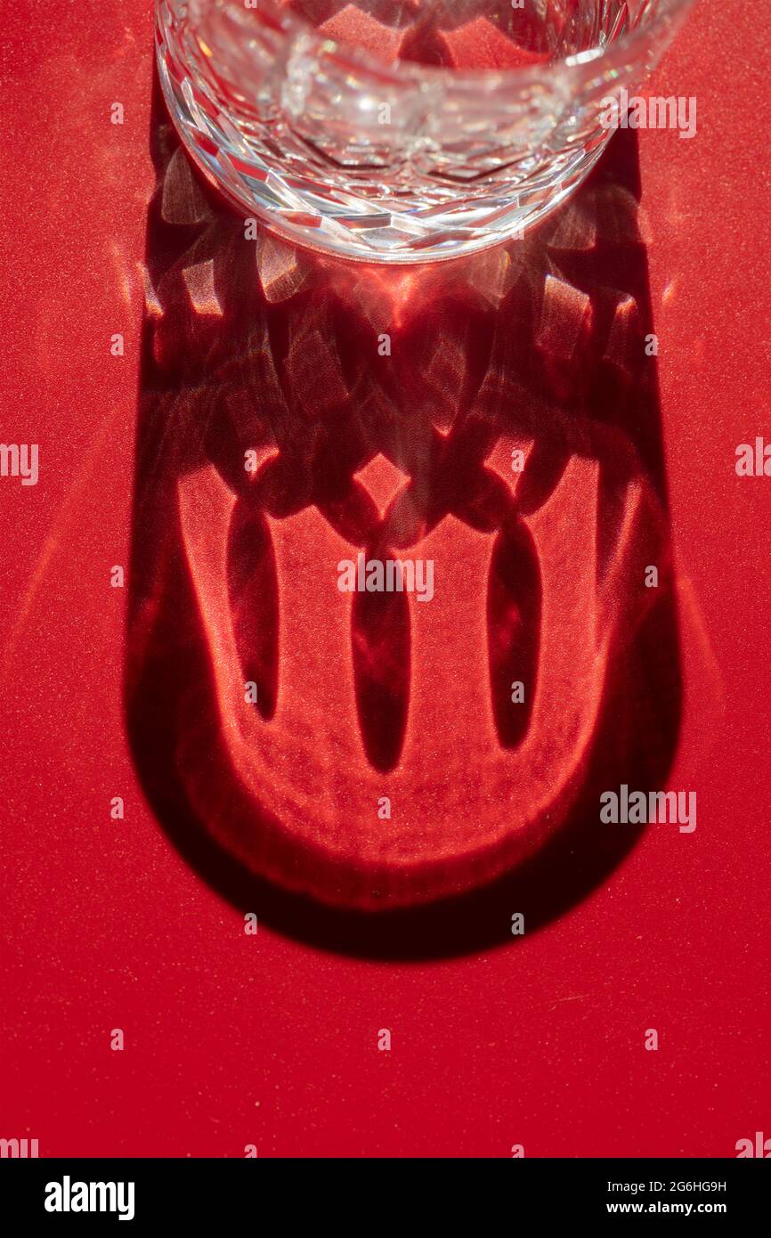 Still-life of crystal glass and prominent reflection pattern on ...