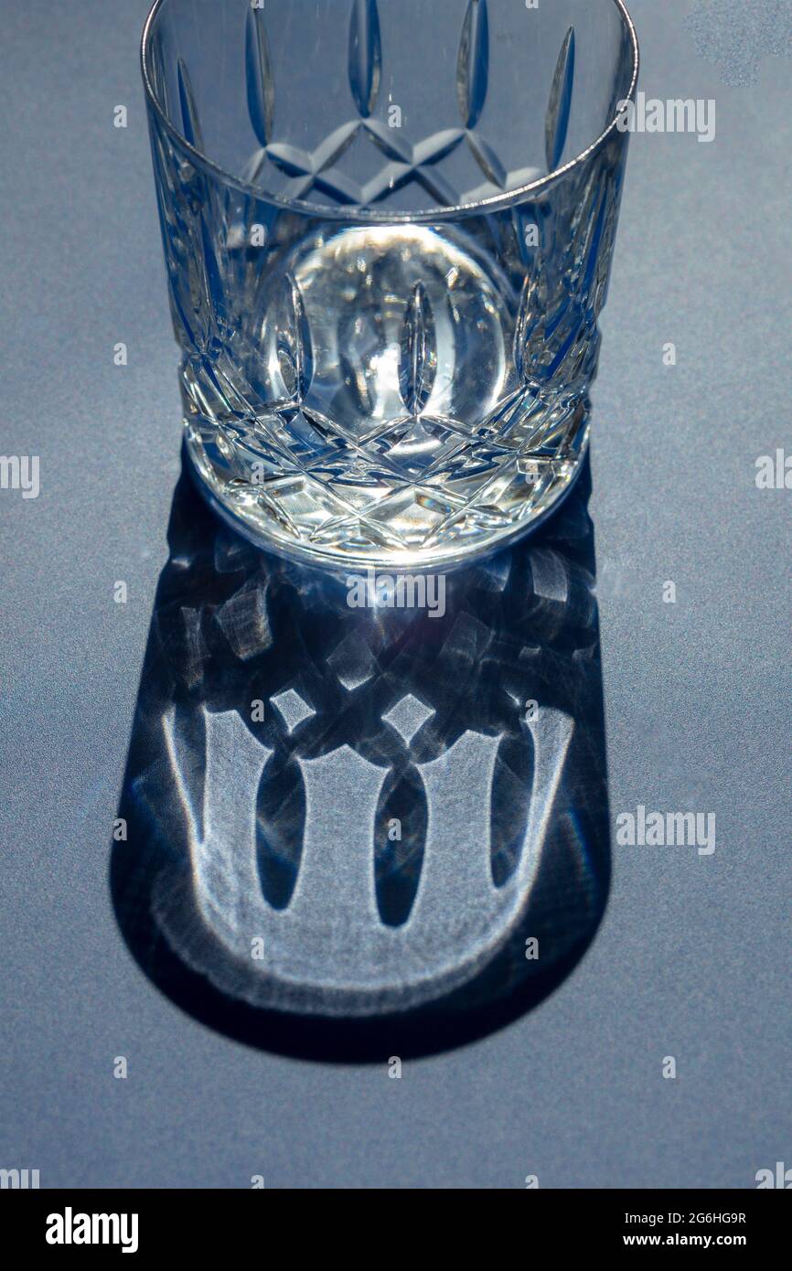 Still-life of crystal glass and prominent reflection pattern on ...