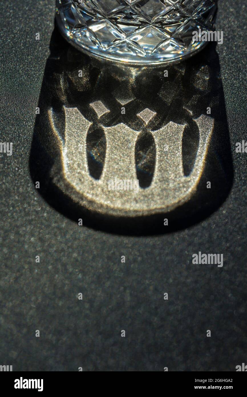 Still-life of crystal glass and prominent reflection pattern on ...