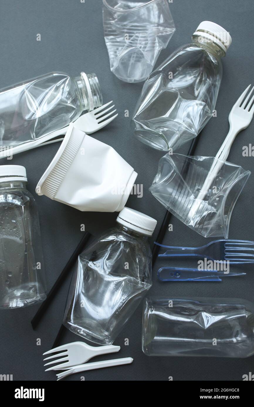 Plastic waste on a gray background. The concept of plastic recycling ...