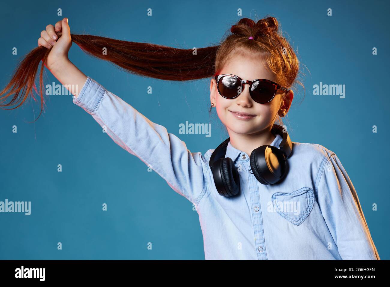 redhead child girl in sunglasses and wireless headphones Stock Photo ...
