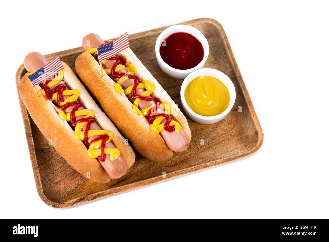 wooden tray with hot dogs and bowls with ketchup and mustard isolated ...
