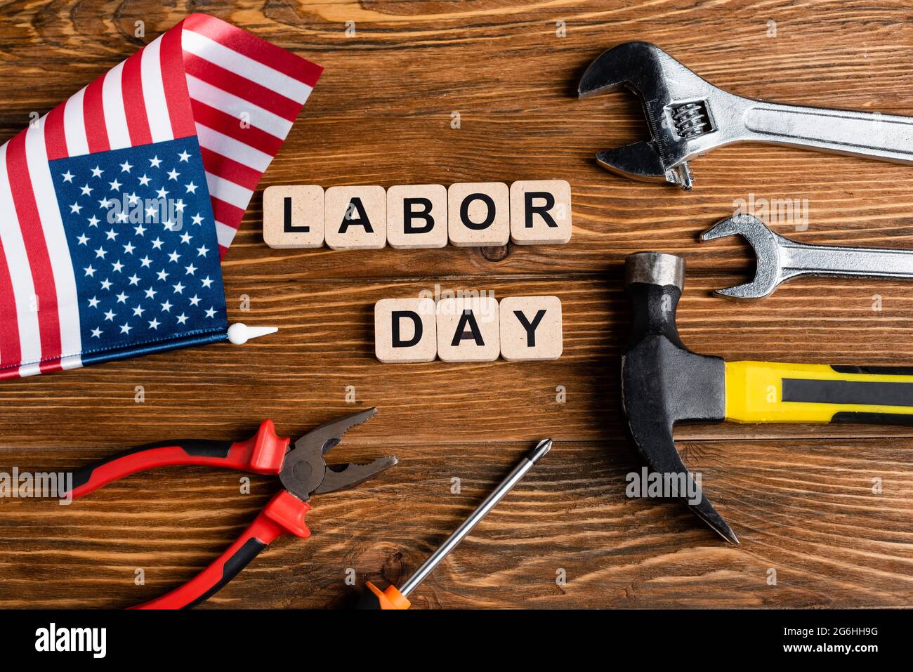 top view of cubes with labor day lettering near various tools and small ...