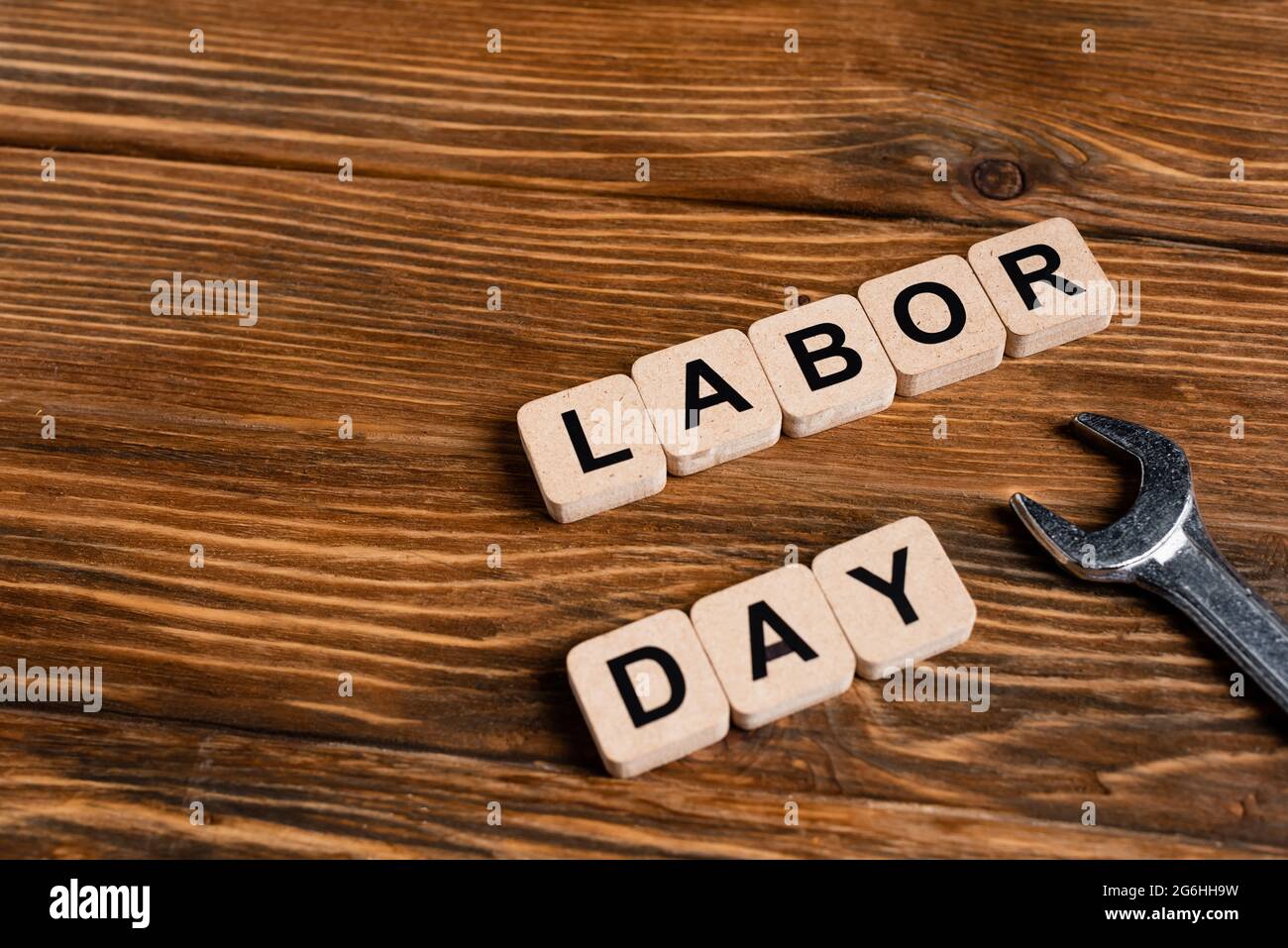 wrench near cubes with labor day lettering on wooden table Stock Photo ...