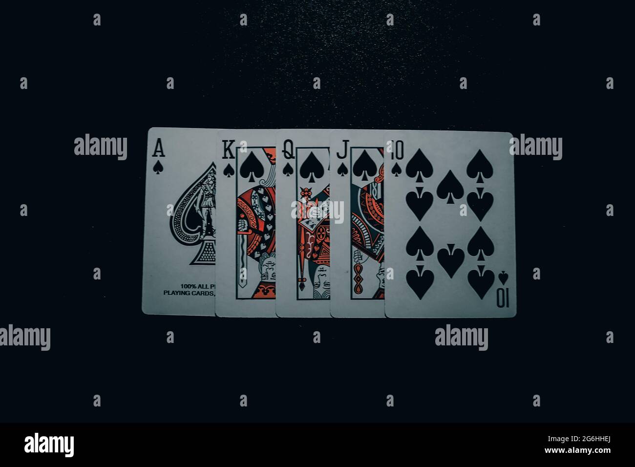 Arrangement of playing cards on a black background Stock Photo - Alamy