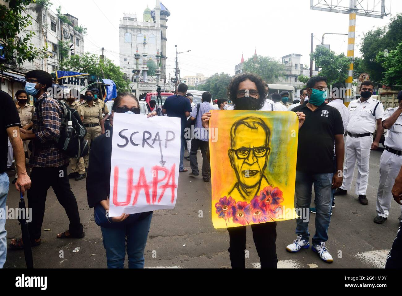 Students display a protest placard and a drawing of Stan Swamy ...