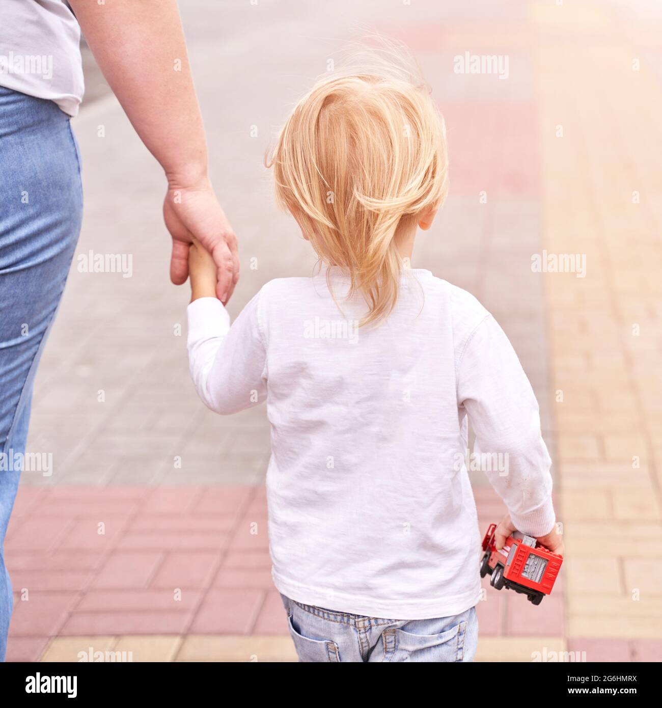 Mother hold sun hand. Outdoor family lifestyle Stock Photo - Alamy