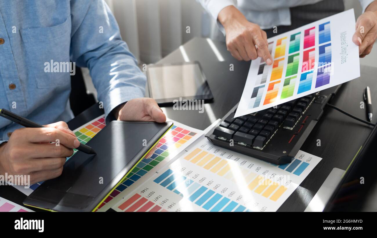 graphic designer team working on web design using color swatches ...