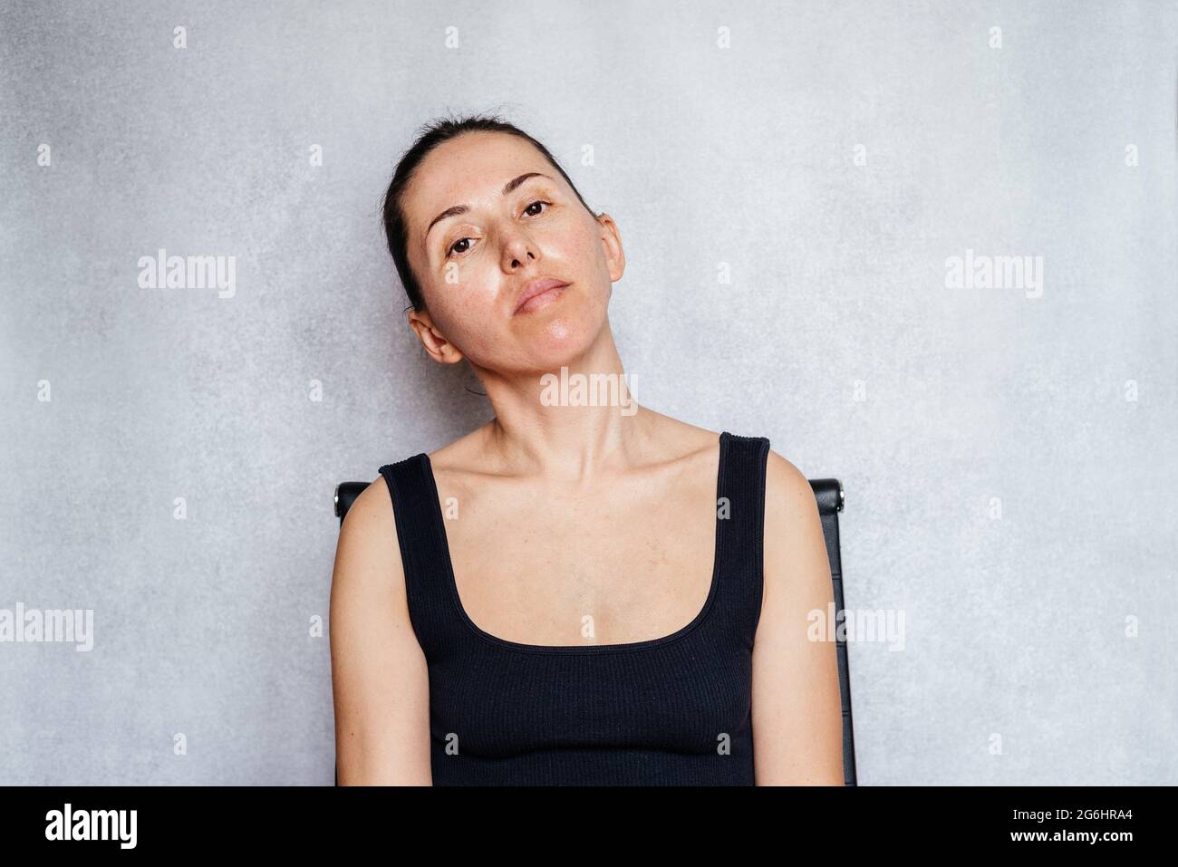 McKenzie method exercise to relieve neck pain, a woman gently rotates ...