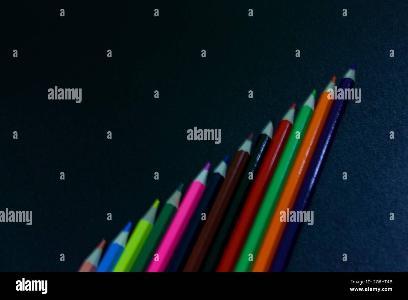 Colored pencils on a black background Stock Photo - Alamy