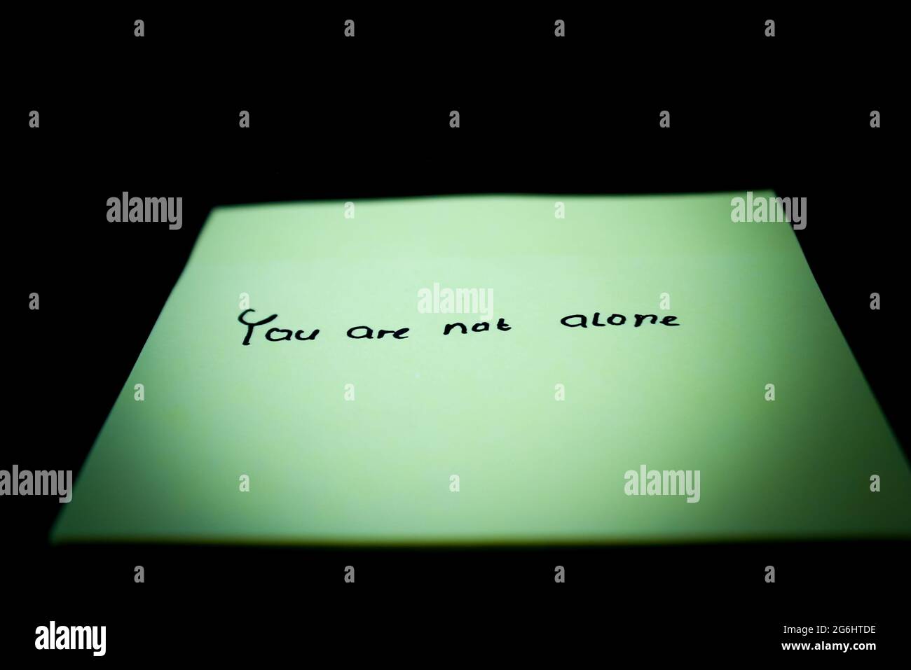 Writing words on a piece of note paper Stock Photo - Alamy