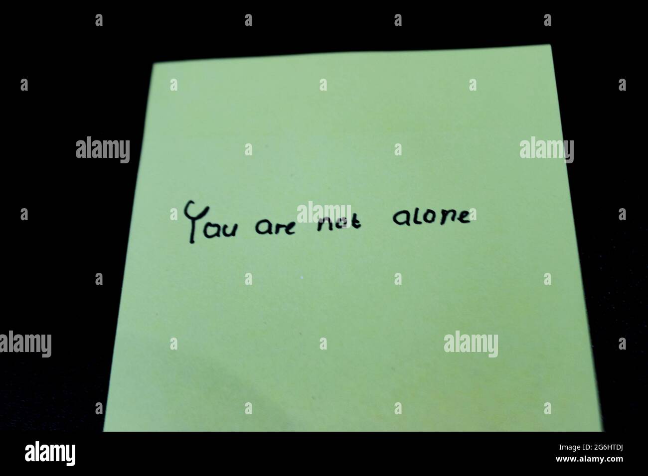 Writing words on a piece of note paper Stock Photo - Alamy