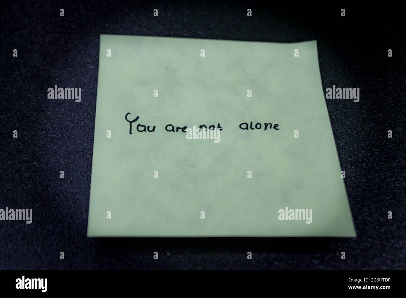 Writing words on a piece of note paper Stock Photo - Alamy