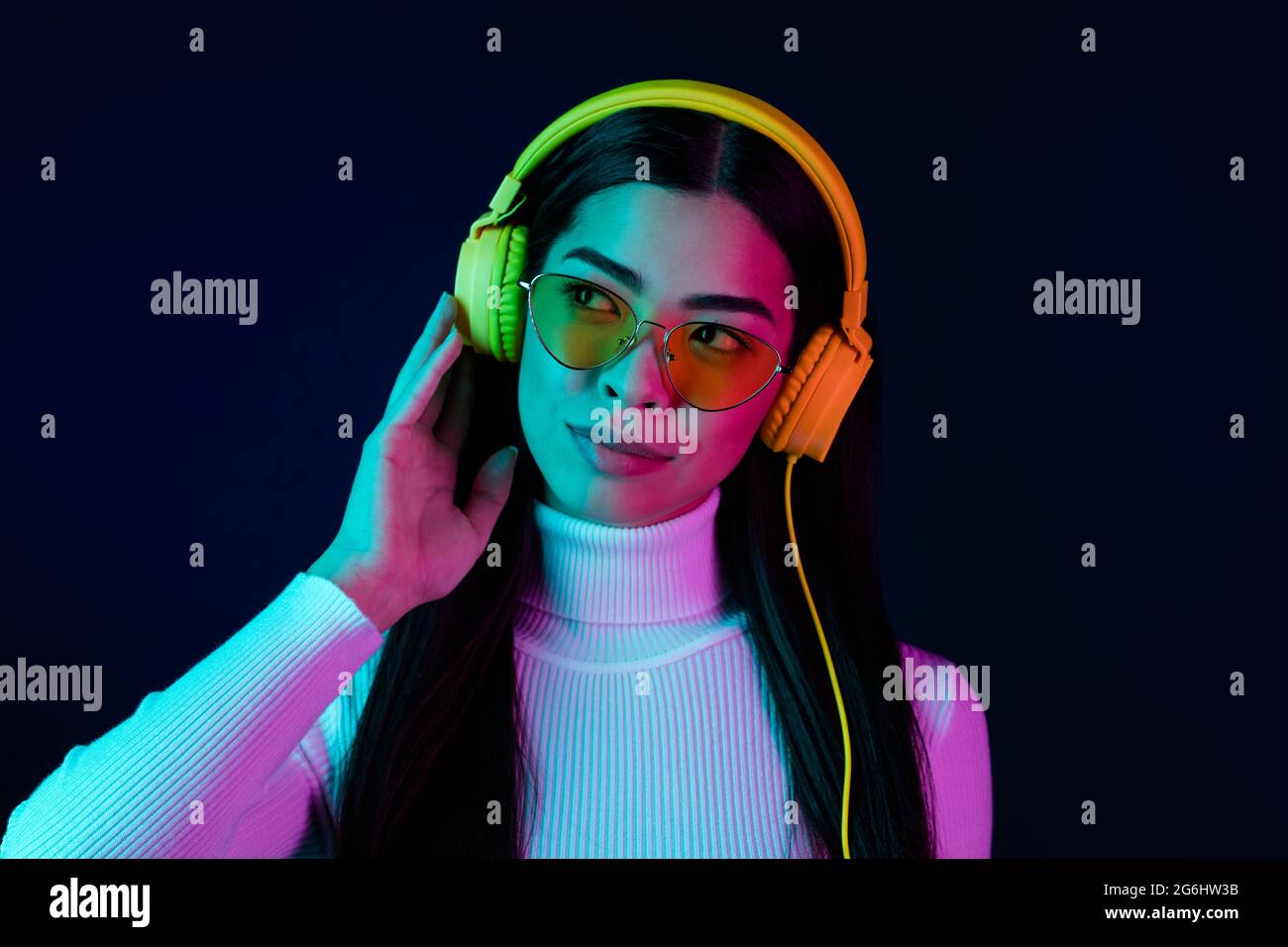 Photo of young girl happy positive smile hand touch headphones listen ...