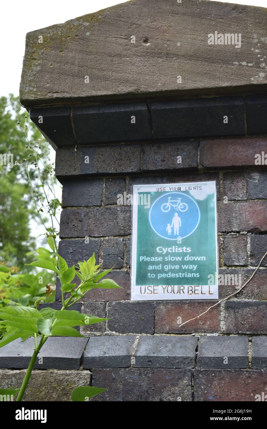 Sign for cyclists: "Cyclists please slow down and give way to ...