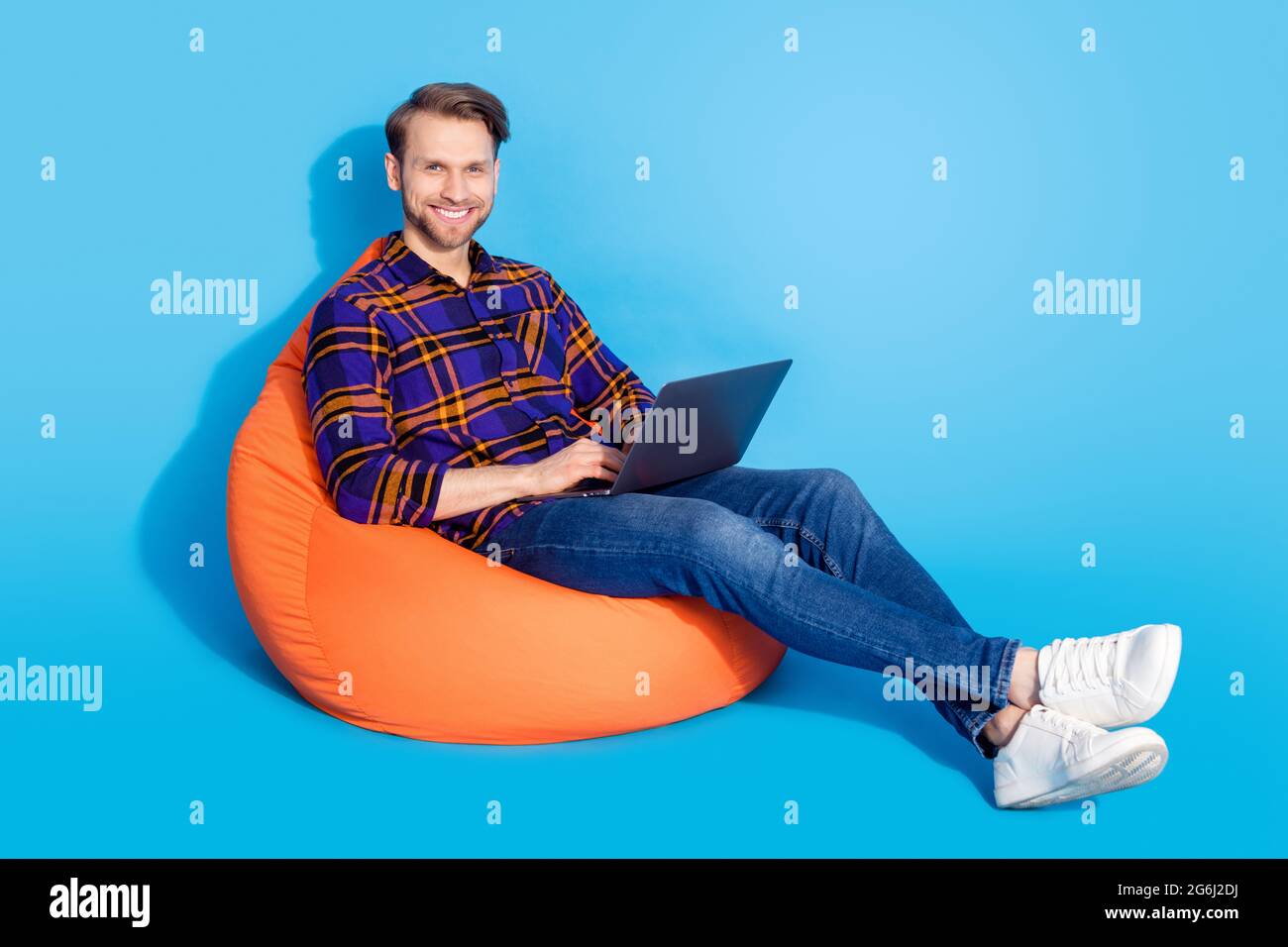 Full length profile photo of positive candid person sit on soft chair ...