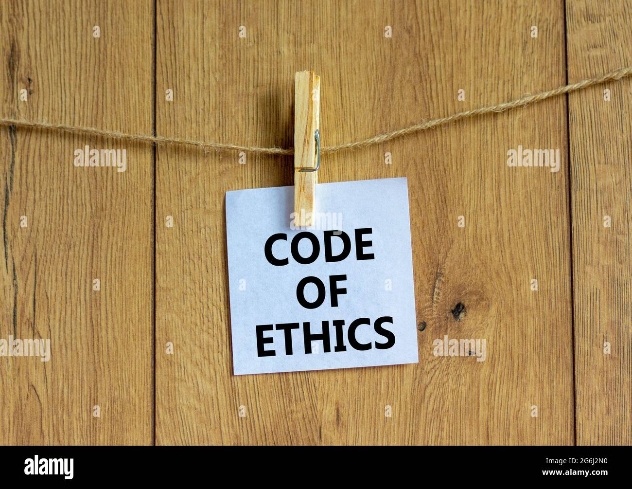 Code of ethics symbol. White paper with words 'Code of ethics', clip on ...